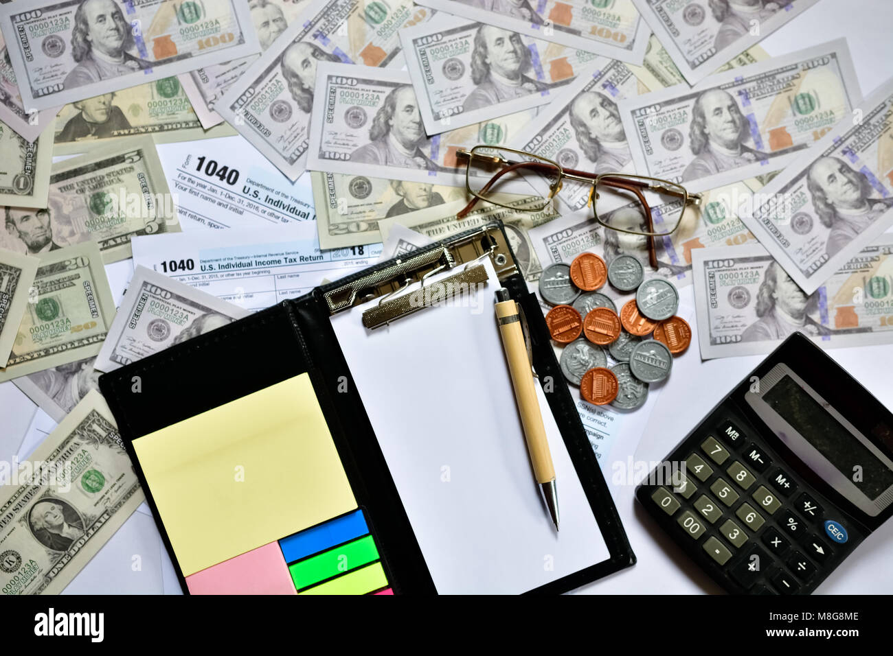 Tax form with notepad, pen and calculator on dollar note Stock Photo ...