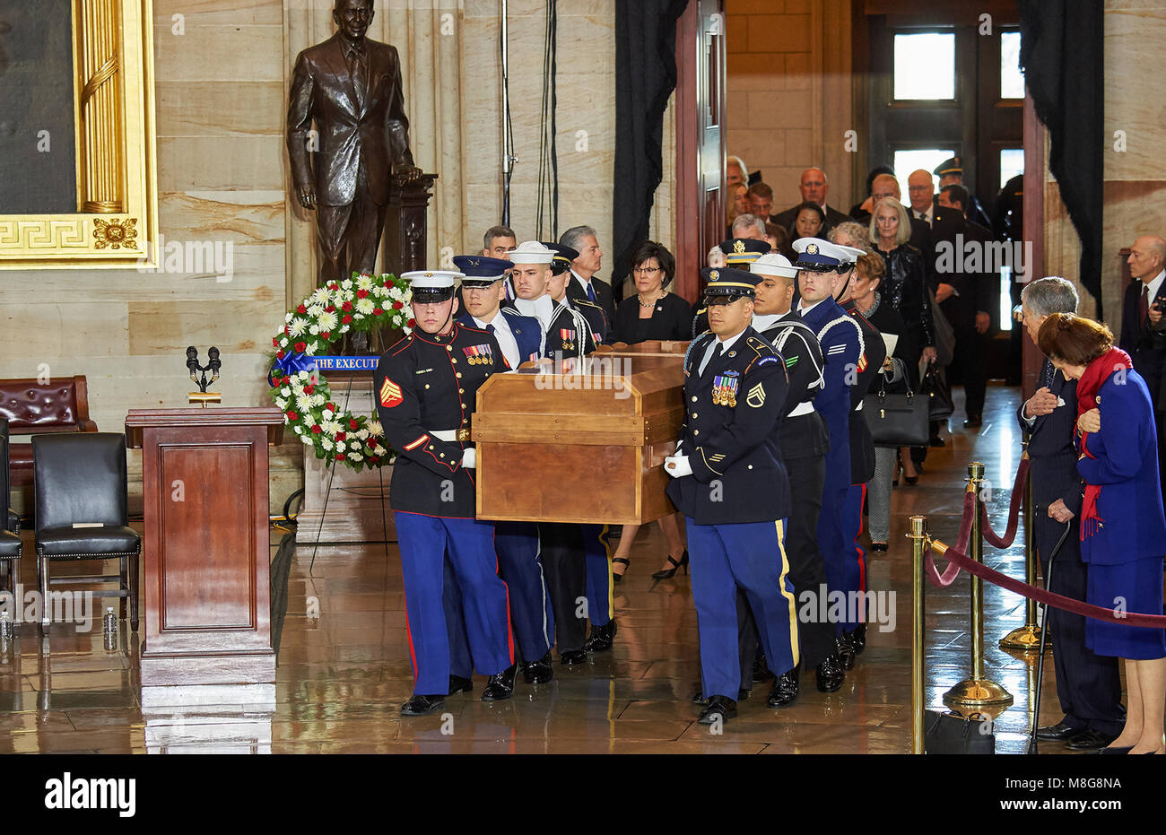 A military honor guard carries the casket of evangelist Christian ...