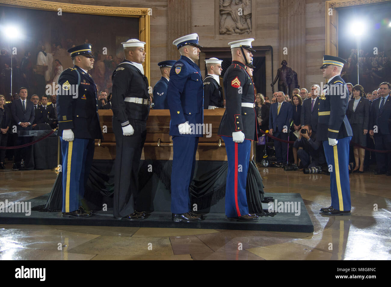 A military honor guard carries the casket of evangelist Christian ...