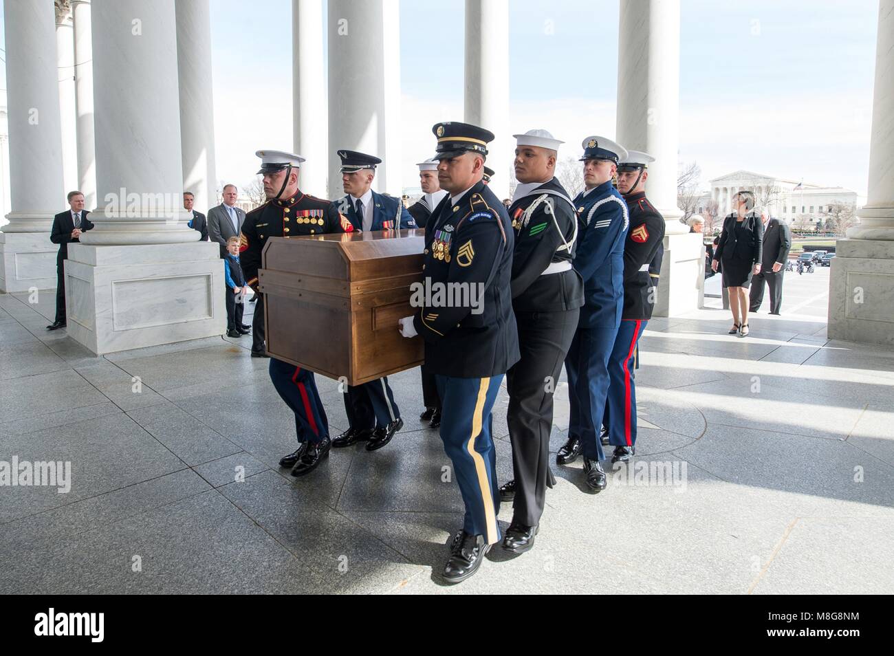 A military honor guard carries the casket of evangelist Christian ...