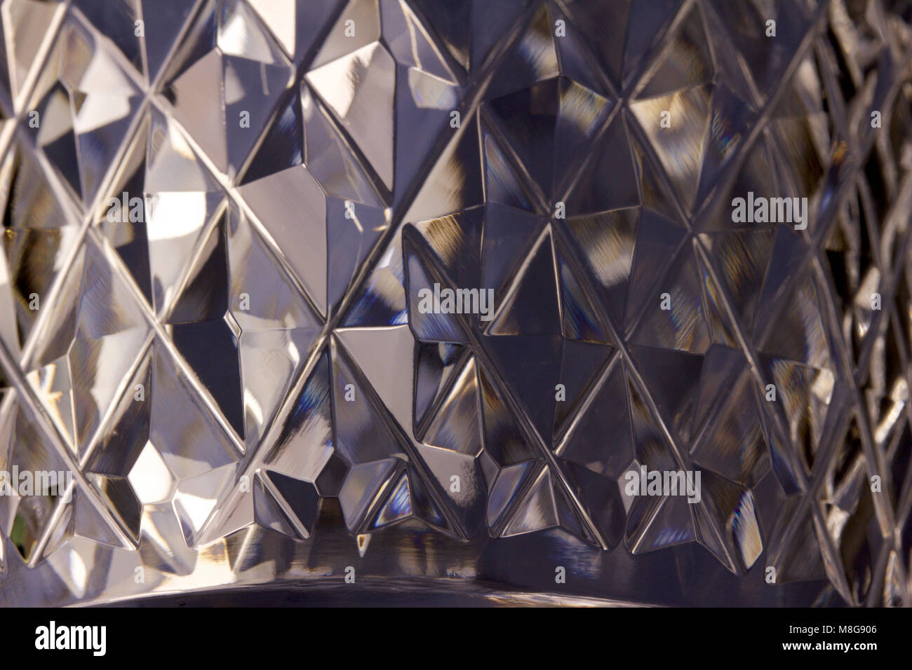 Macro abstract of brilliant lead crystal diamond cut facets in bright ...