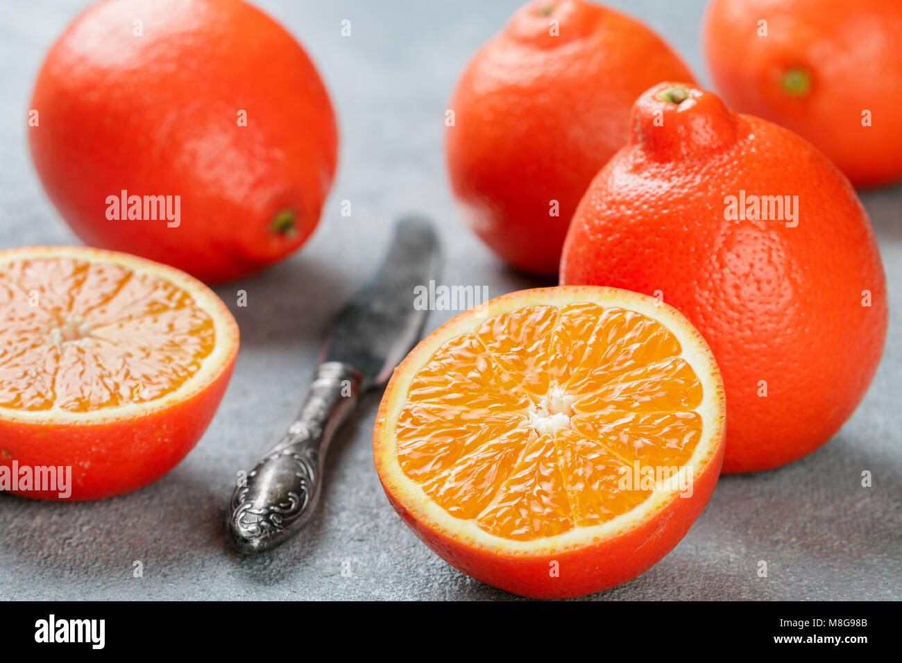Mineola. Tangerine. Juicy sweet orange citrus fruit whole and sliced on ...