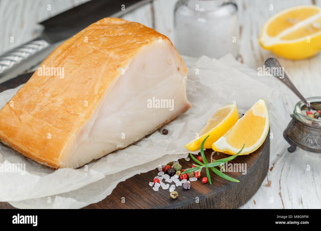 Salted white fish with lemon, rosemary and spices salt and pepper ...