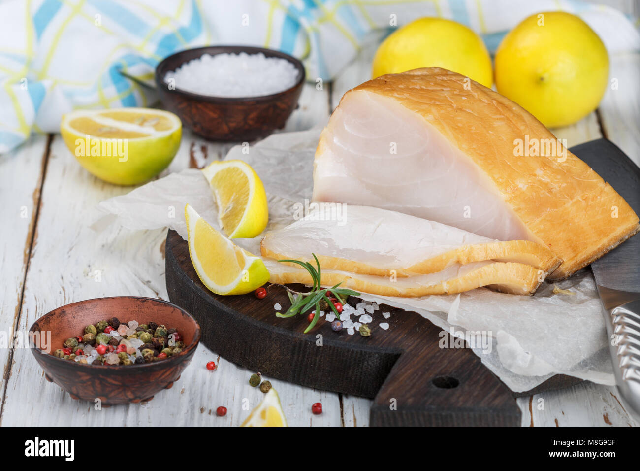 Salted white fish with lemon, rosemary and spices salt and pepper ...