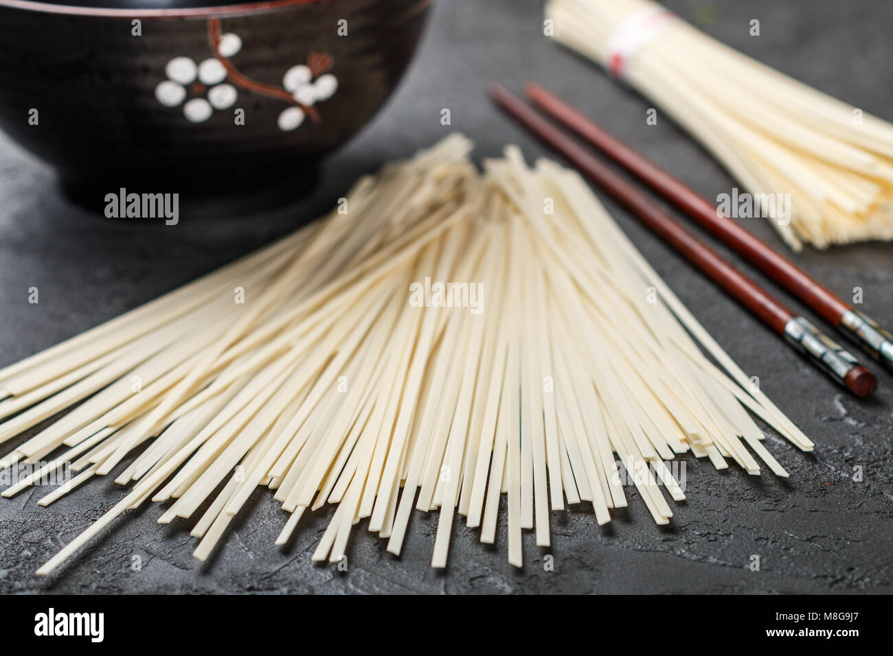 Raw Udon noodles for cooking Oriental and Asian cuisine on black ...