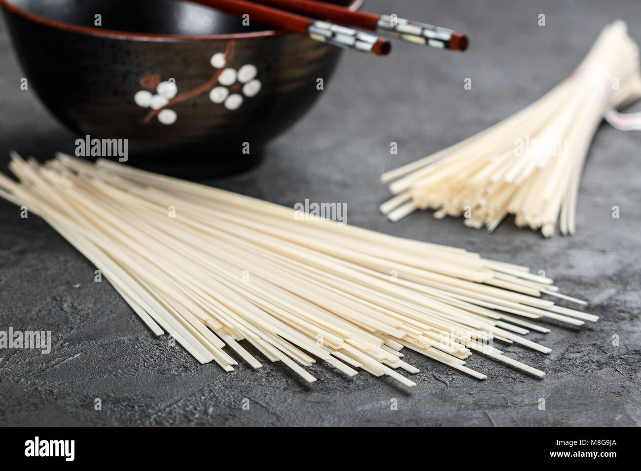 Raw Udon noodles for cooking Oriental and Asian cuisine on black ...