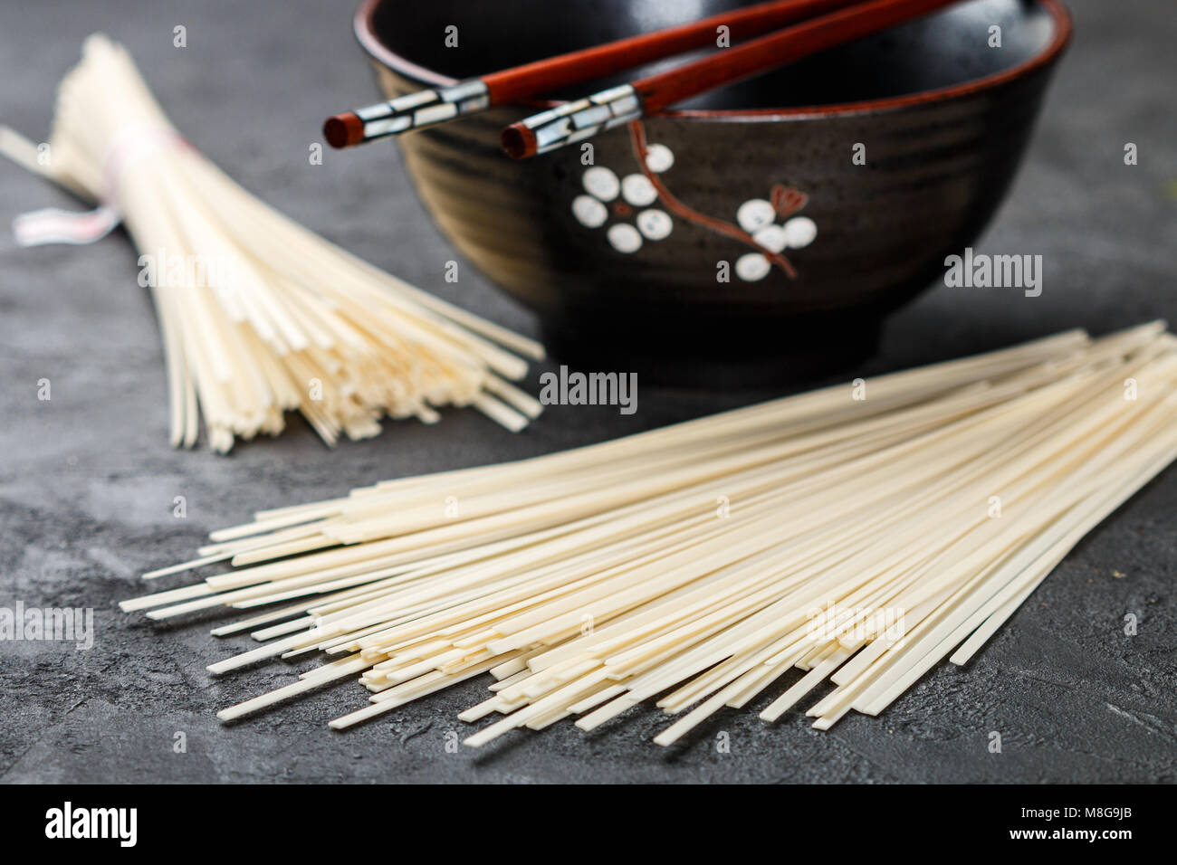 Raw Udon noodles for cooking Oriental and Asian cuisine on black ...