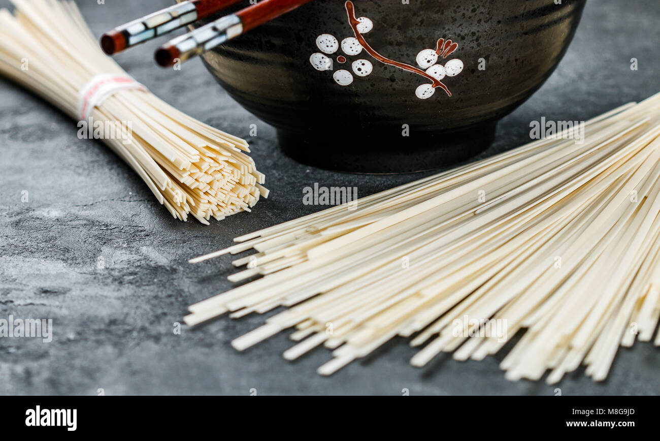 Raw Udon noodles for cooking Oriental and Asian cuisine on black ...
