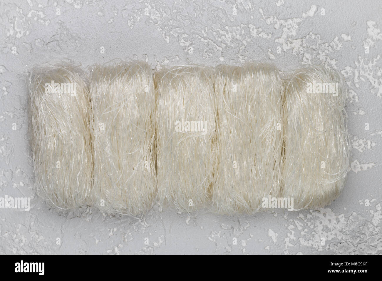 Asian uncooked vermicelli. Several bundles or rolls of dried starch ...