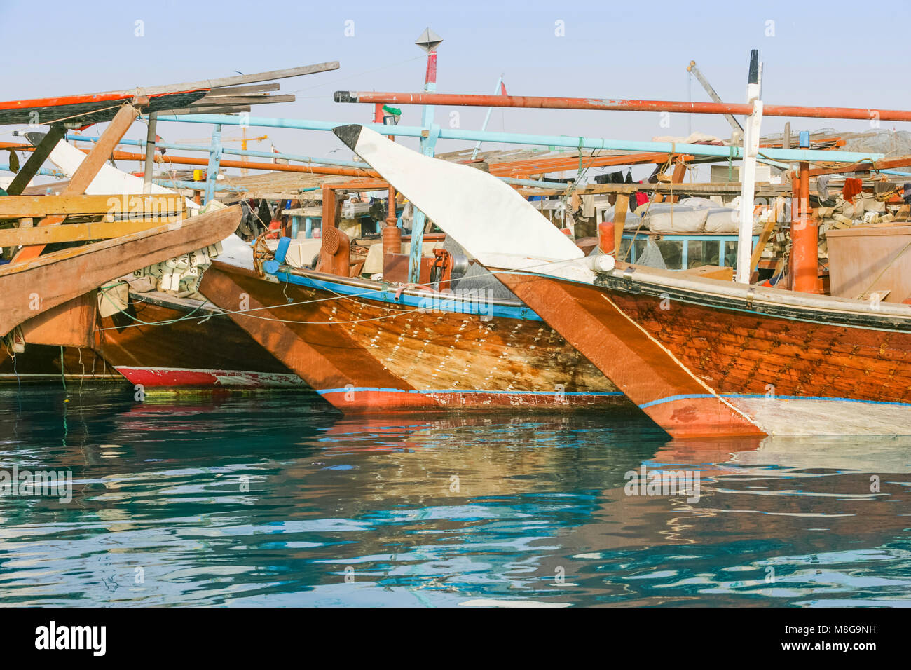 Traditional wooden fishing dhows berthed in the Dhow Harbour in Abu ...