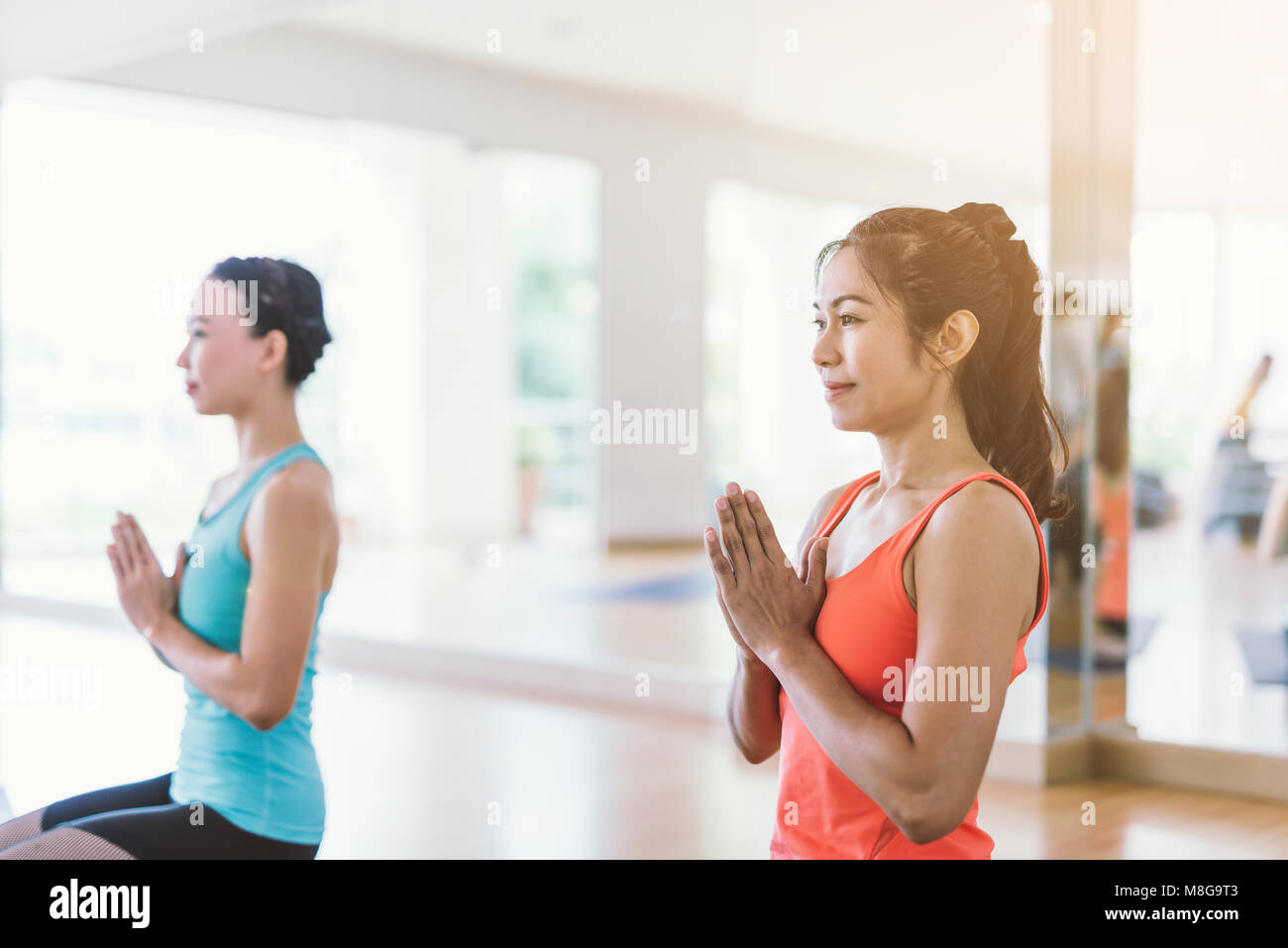 fitness, sport, training, yoga and people concept - Asian woman do ...