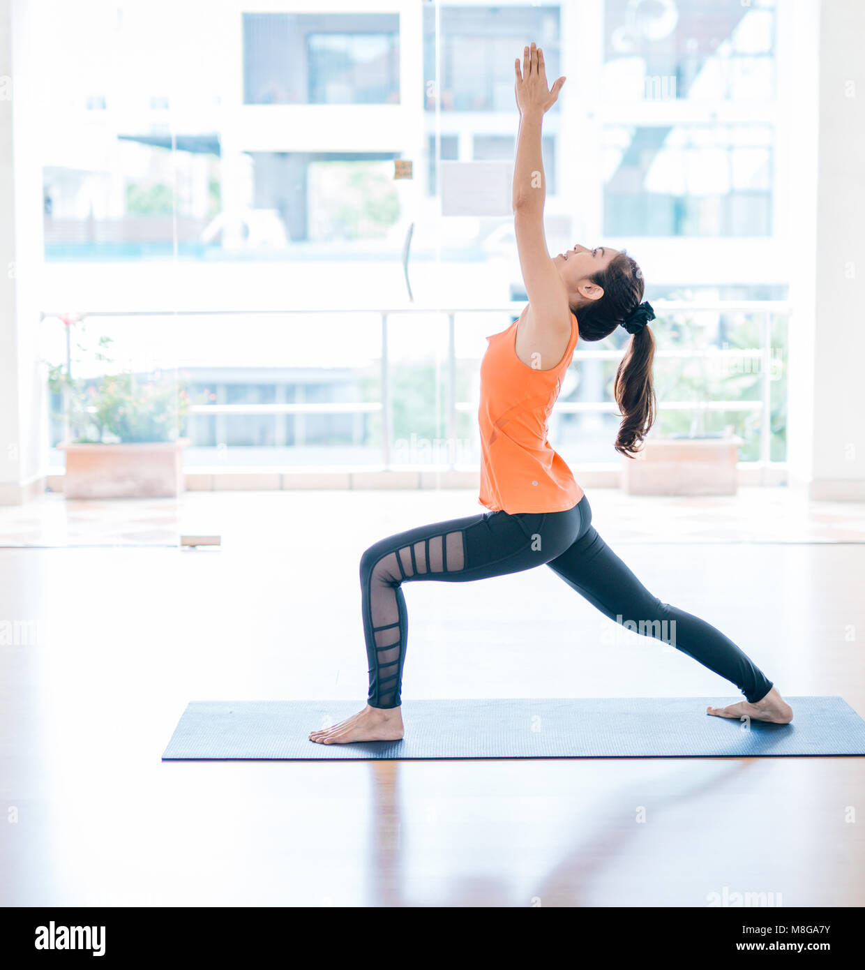 Portrait of beautiful young woman enjoying yoga indoors. Yogi girl ...