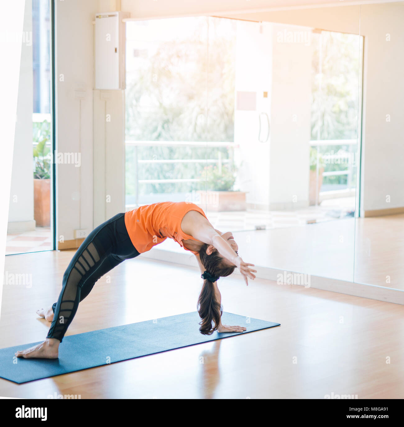 Portrait of beautiful young woman enjoying yoga indoors. Yogi girl ...