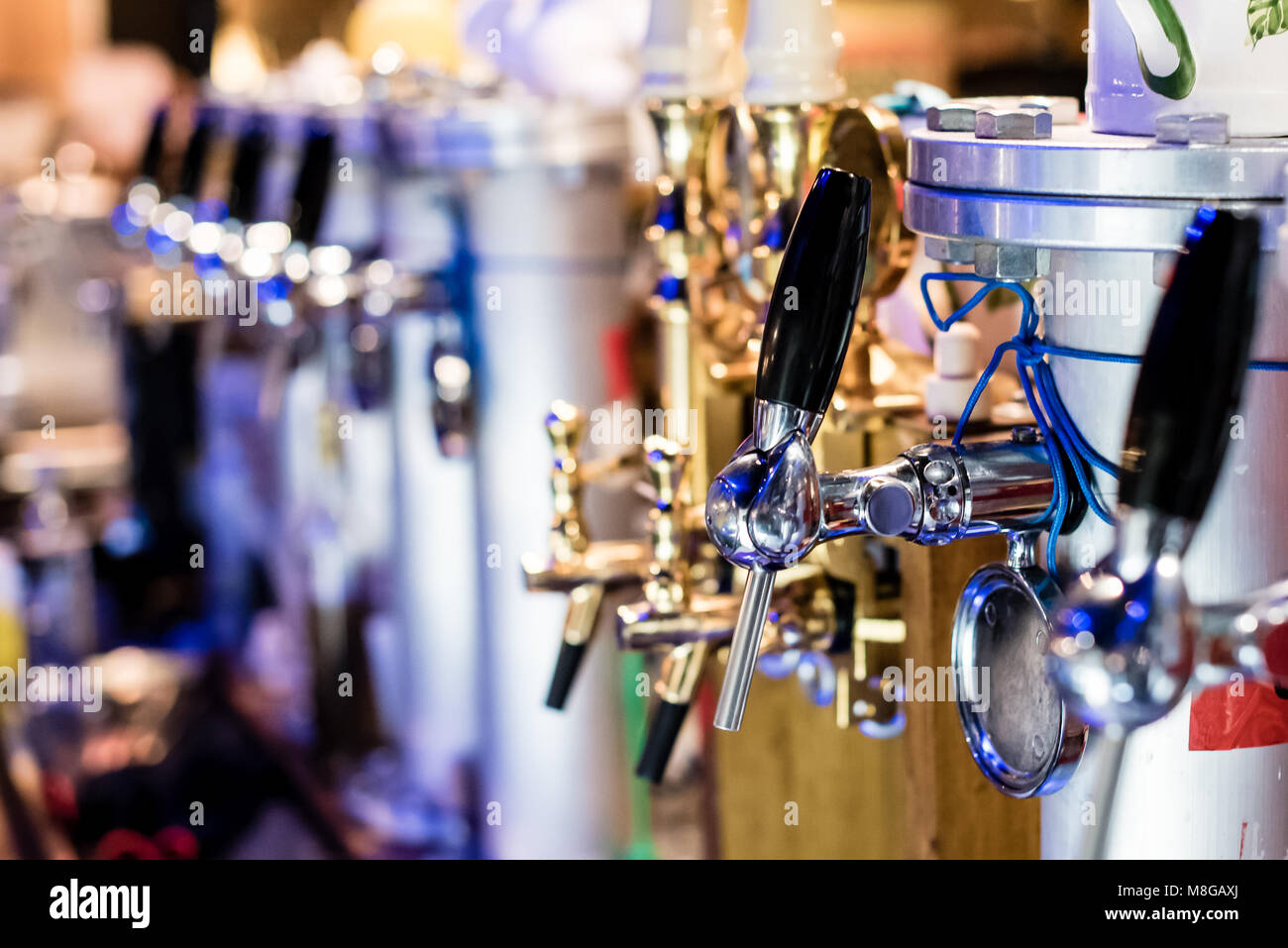 different beer pumps, selective focus and bokeh, interior design of a ...