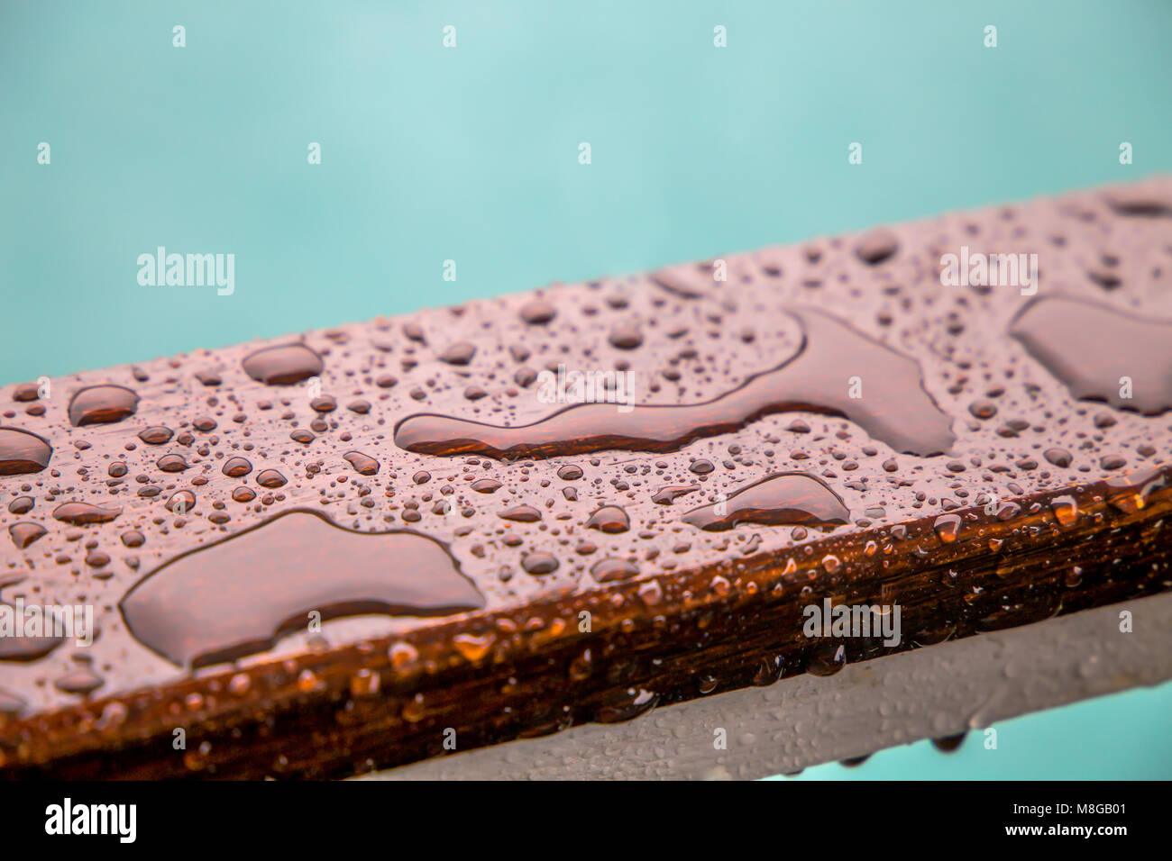 Raindrops on wooden railing/ drips / water/ rain Stock Photo - Alamy