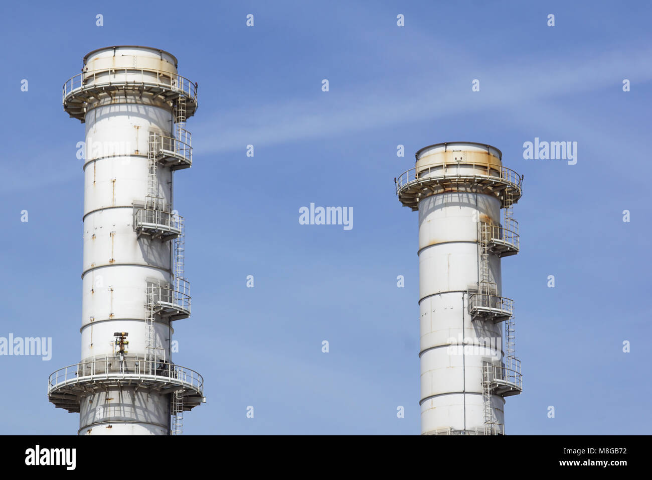 Pipes of industrial factory and blue sky background Stock Photo - Alamy
