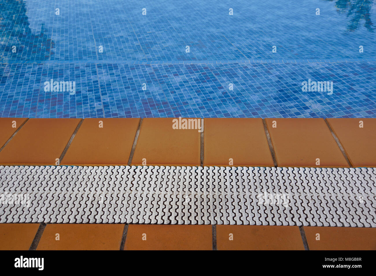 blue swimming pool with teak wood flooring stripes summer vacation ...