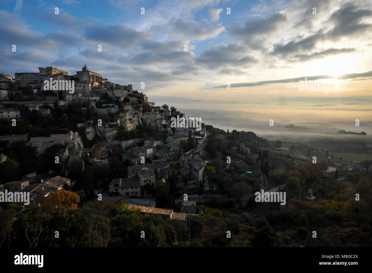 Hill village rising out of the morning mist/fog Stock Photo - Alamy