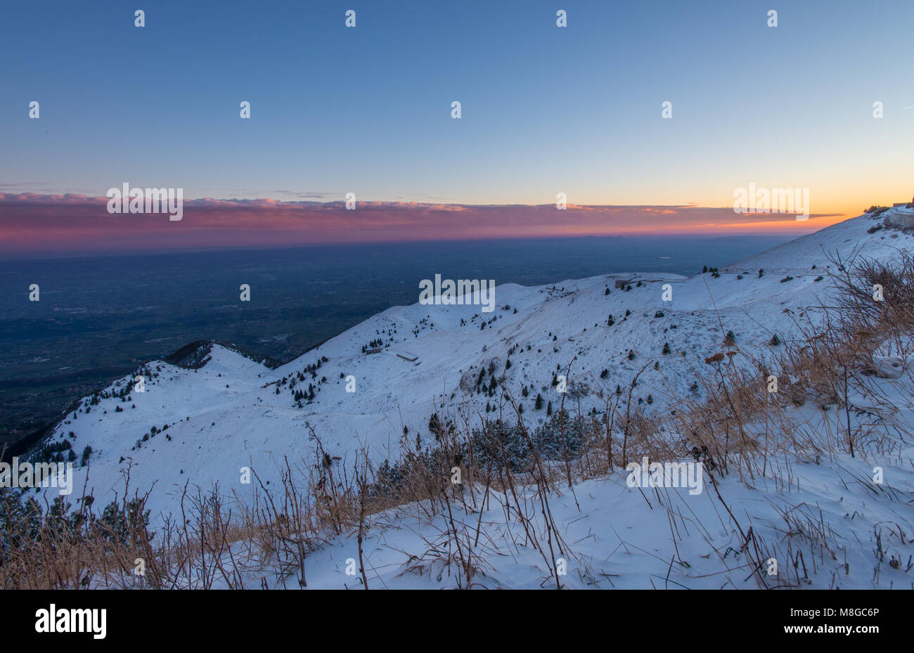 Majestic alpenglow paints mountains and clouds at sunset, looking down ...