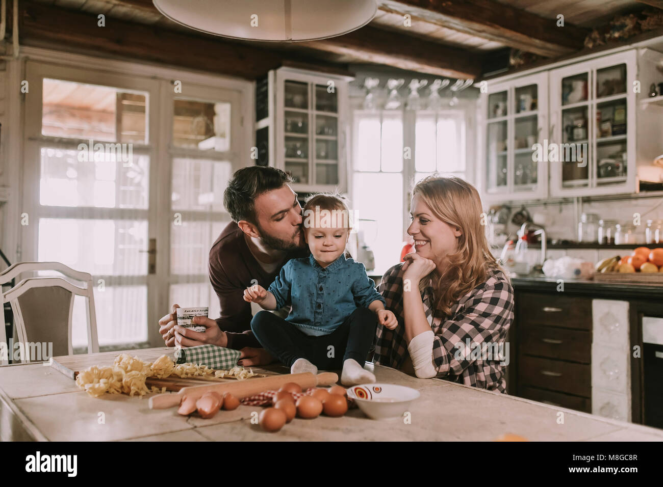 Happy family making pasta in the kitchen at home Stock Photo - Alamy