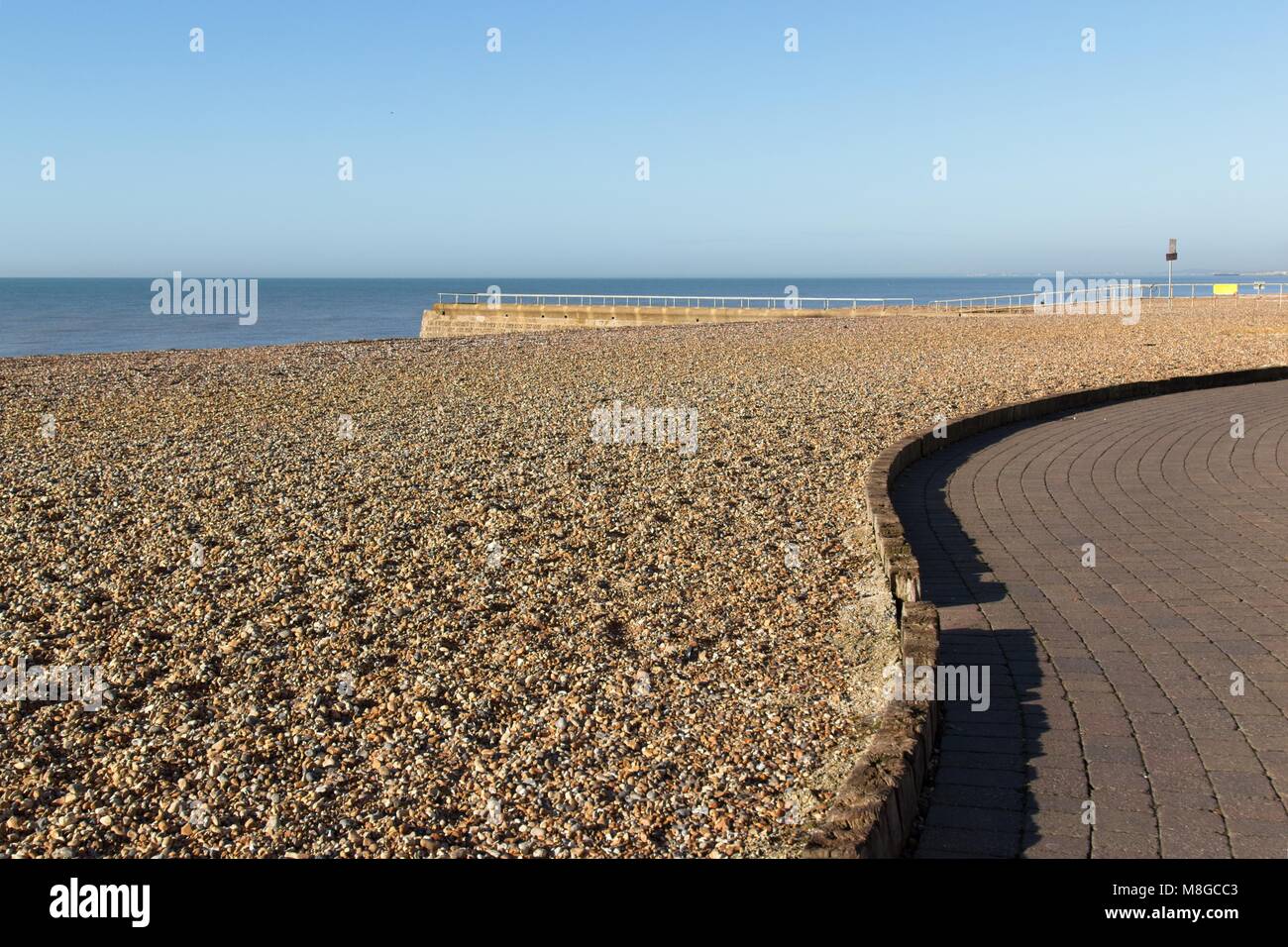 Seafront path alongside pebble beach Stock Photo - Alamy