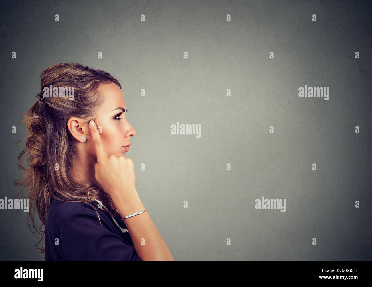 Woman touching temple making hi-res stock photography and images - Alamy