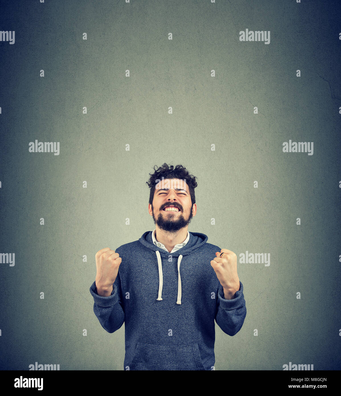 Happy successful student man winning, fists pumped celebrating success ...