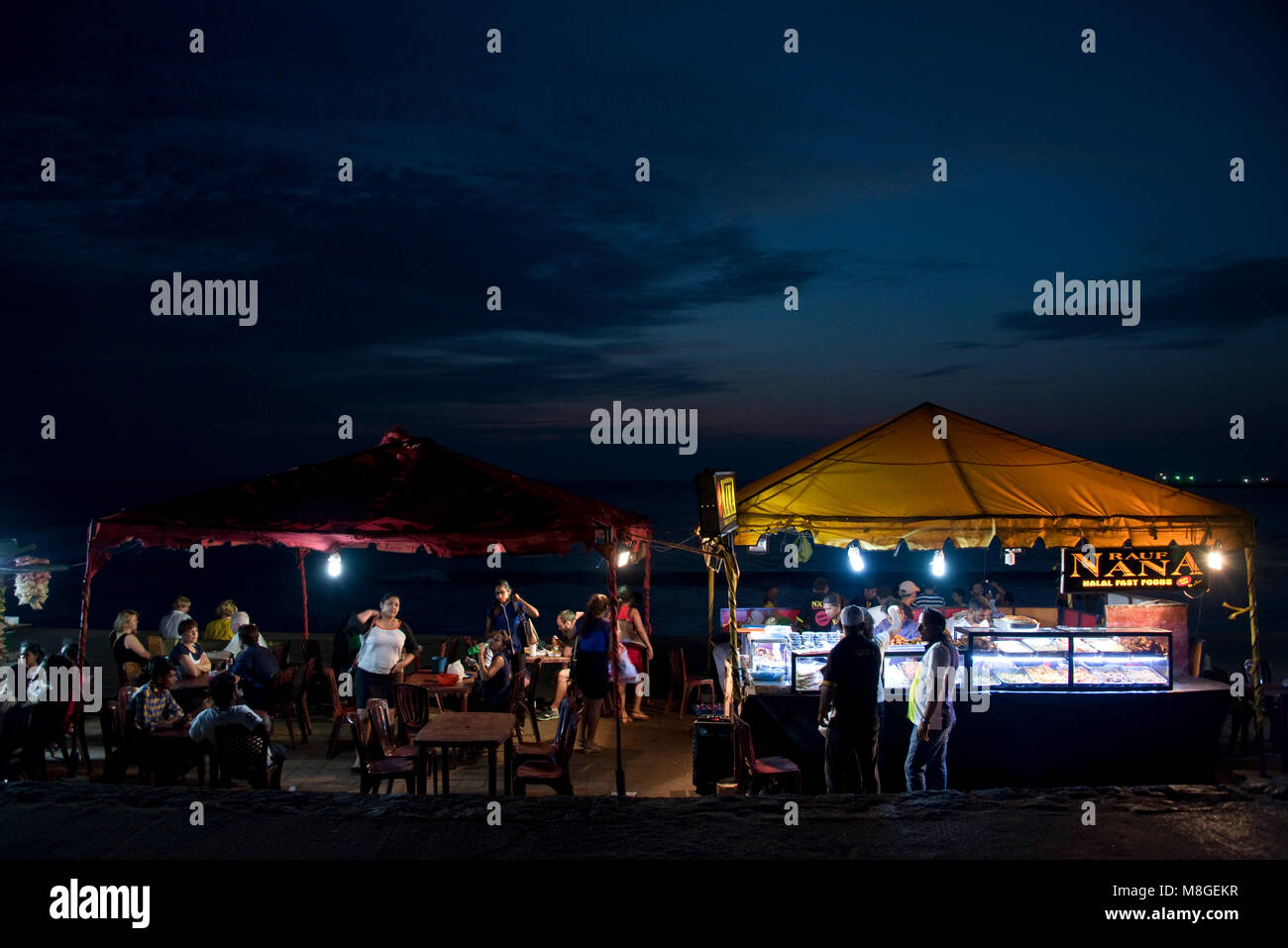 Open air restaurant at the beach in the evening hi-res stock ...