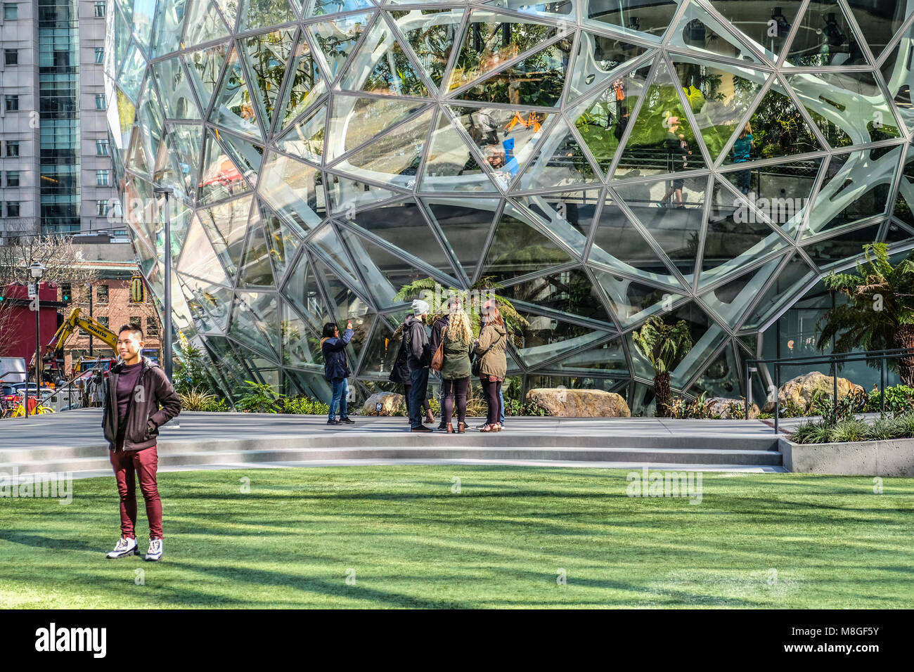 People chat in front of the glass dome Spheres at Amazon headquarter in ...