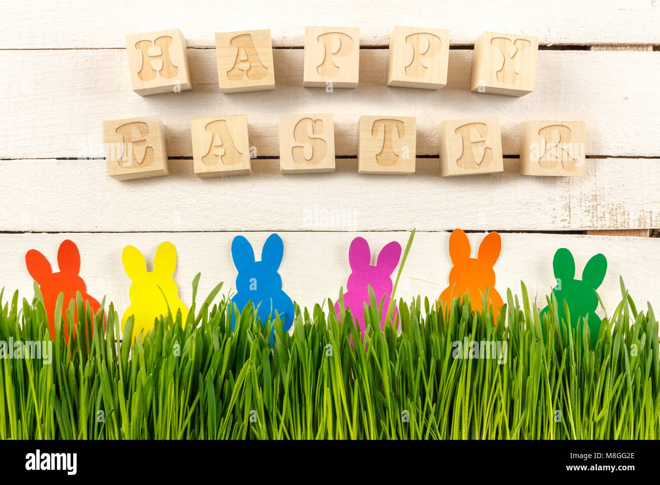 Happy Easter. Cubes with text on a white background. Fresh sprouts and ...