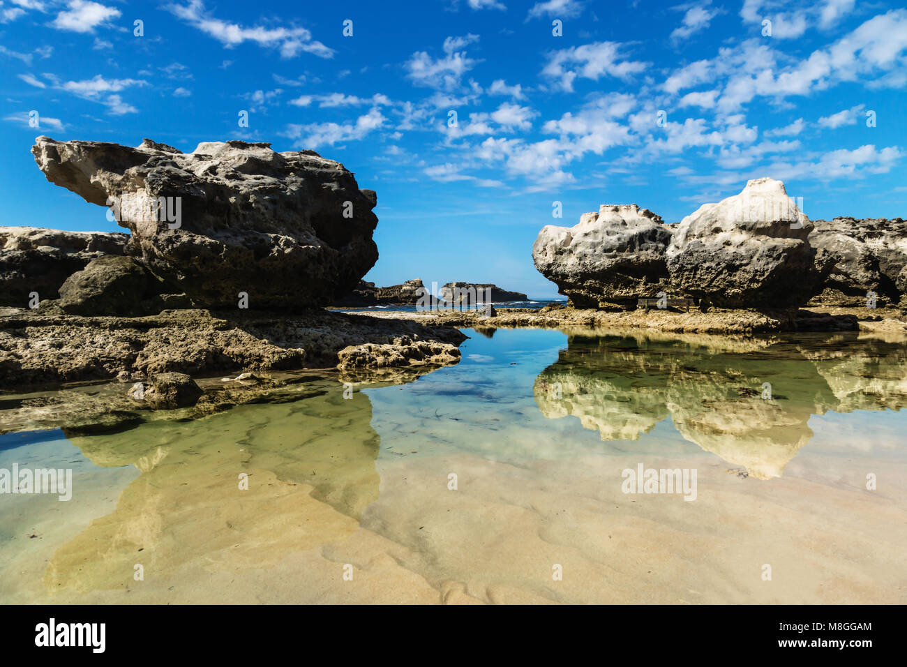Three rock formations with reflections in the sea at Peterborough beach ...
