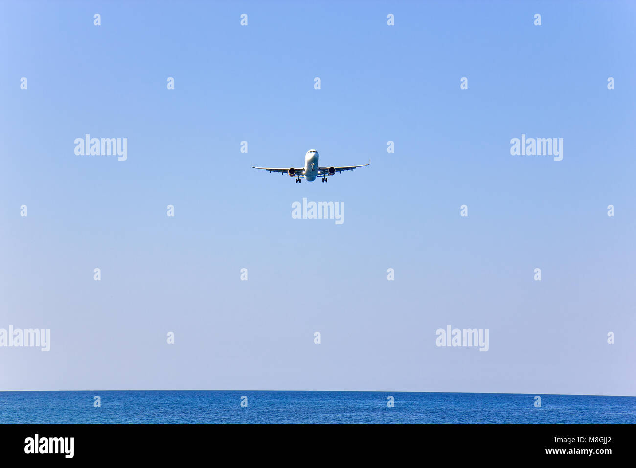 Plane landing above the beach on Skiathos island, Greece Stock Photo ...