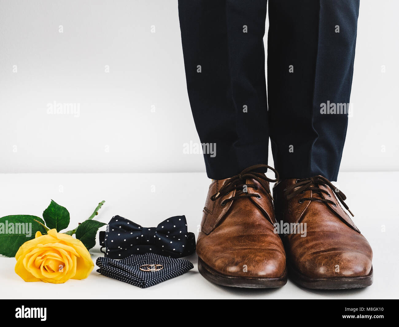 Wedding rings, rose, men's legs Stock Photo - Alamy