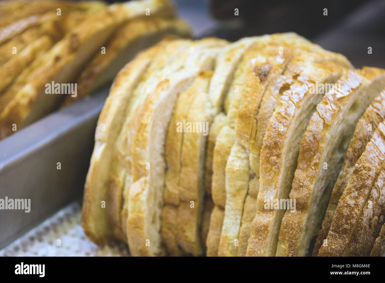 freshly baked bread sliced on the conveyor belt Stock Photo - Alamy