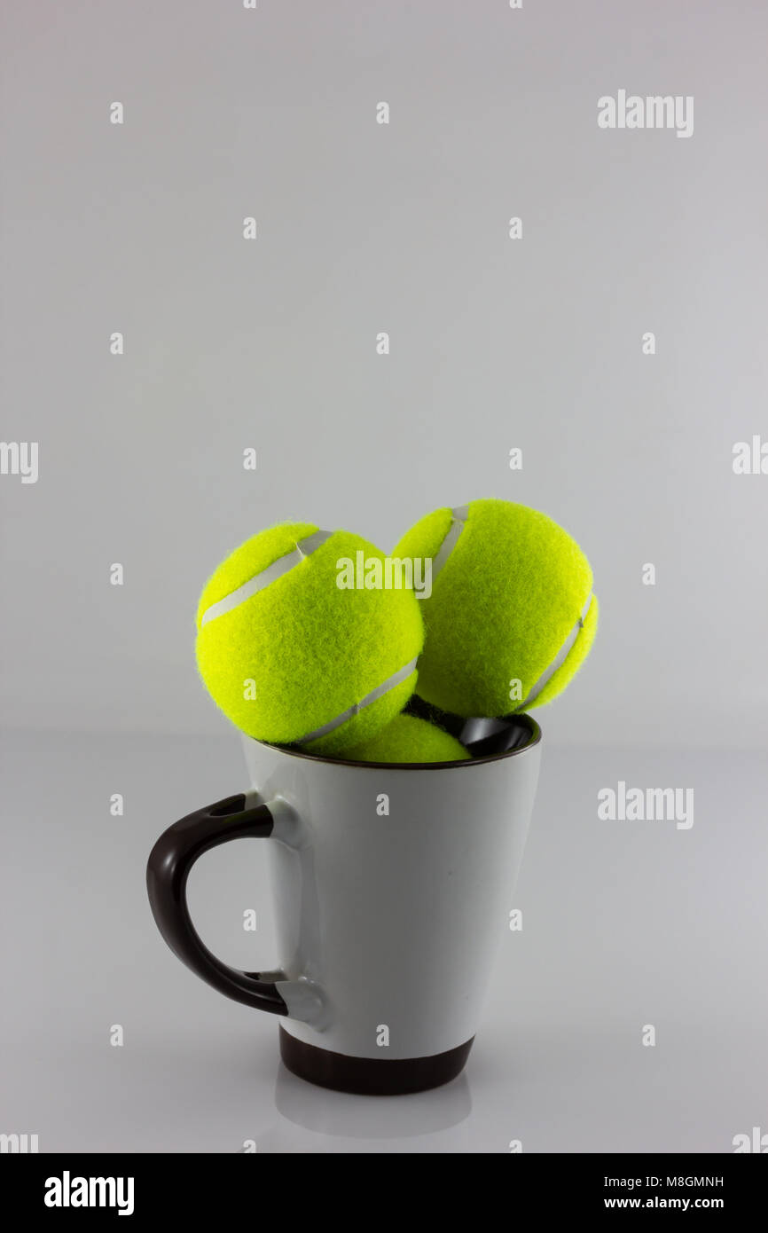 Tennis balls and Cofee cup isolate on white background Stock Photo - Alamy