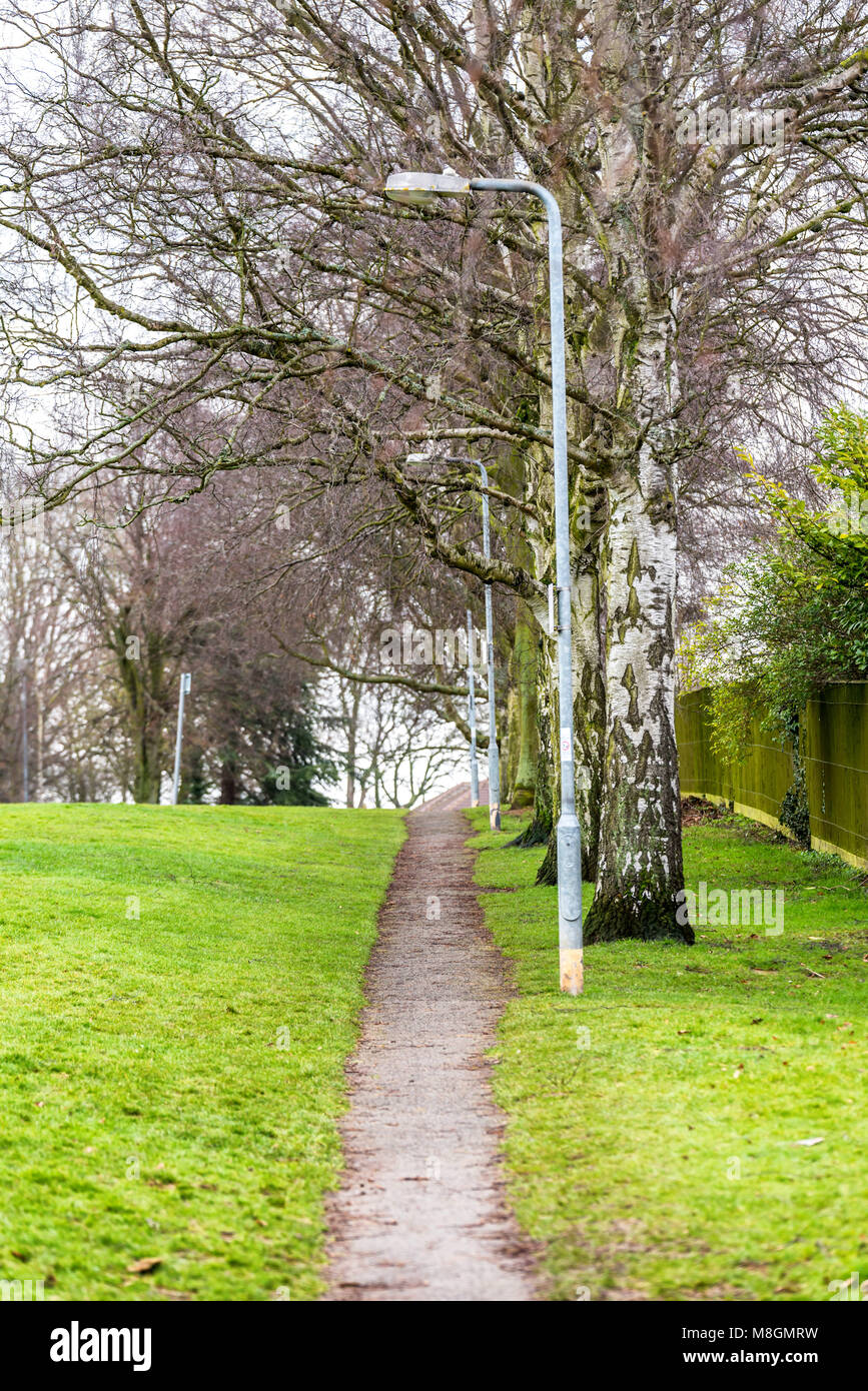 Town park pedestrian footpath with lamp stands in Daventry town centre ...