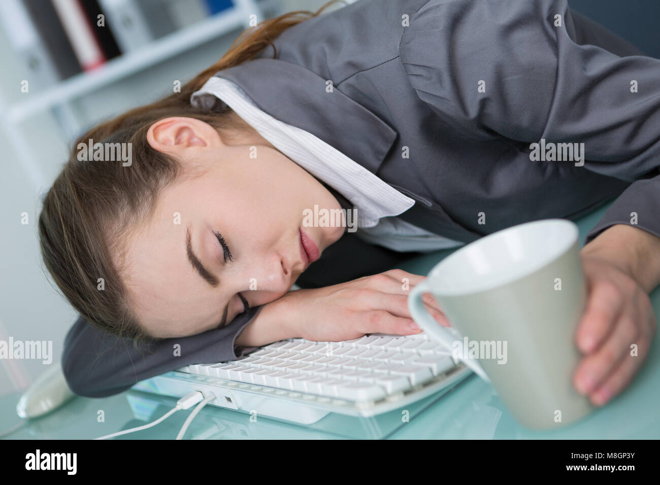 beautiful tired woman sleeping on the keyboard of a laptop Stock Photo ...