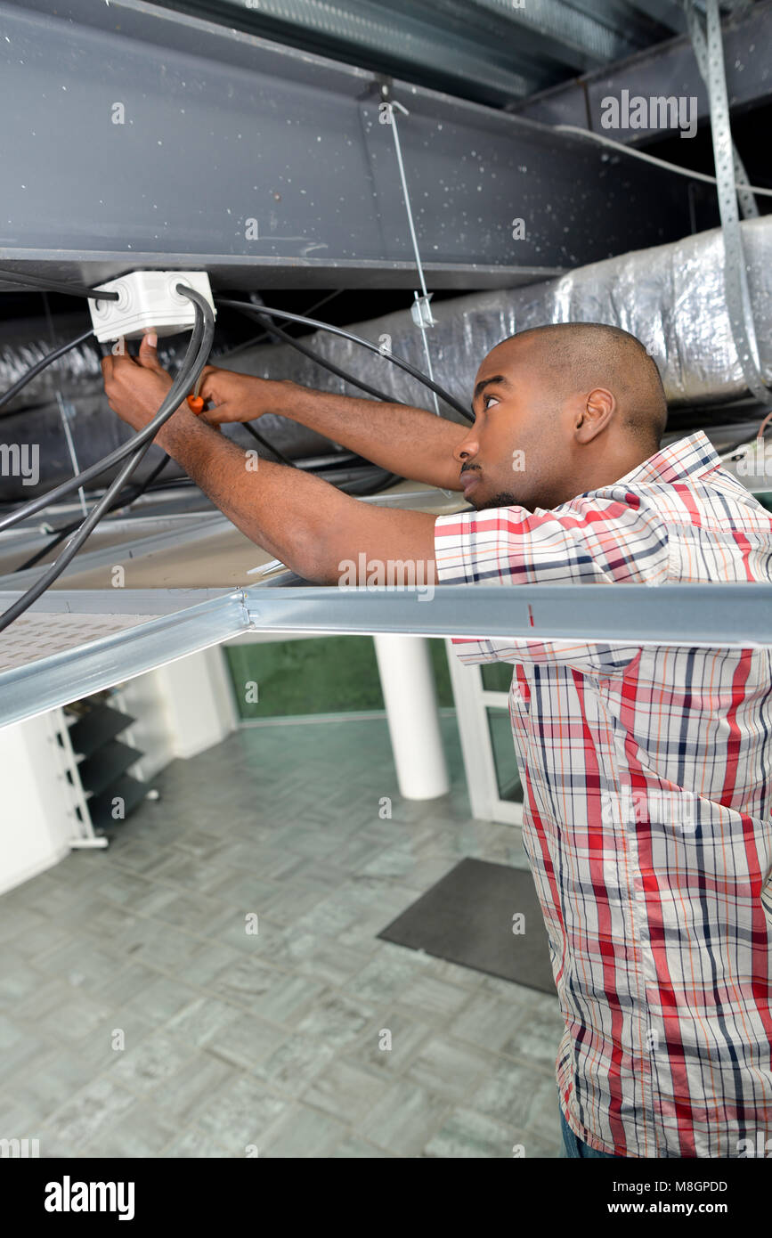 Checking electrical cabling in ceiling Stock Photo - Alamy