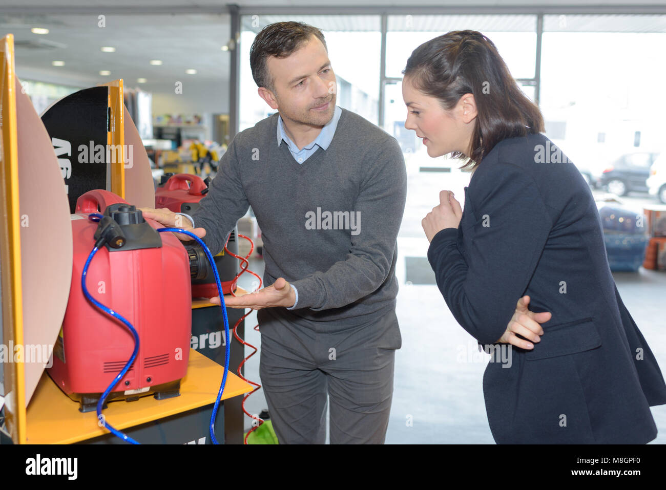 Woman looking at machine on display Stock Photo - Alamy
