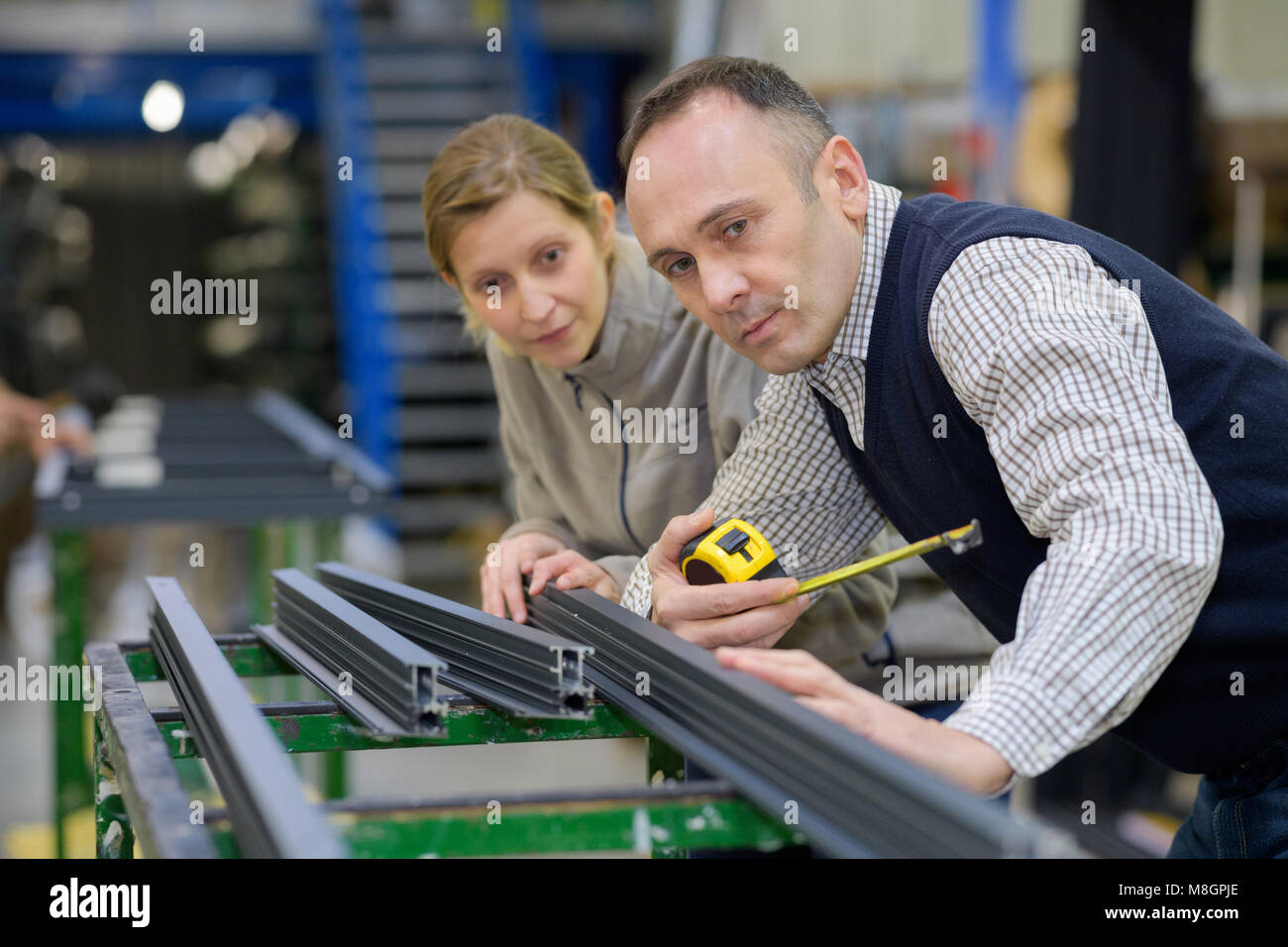 male and female workers in metalworks factory Stock Photo - Alamy