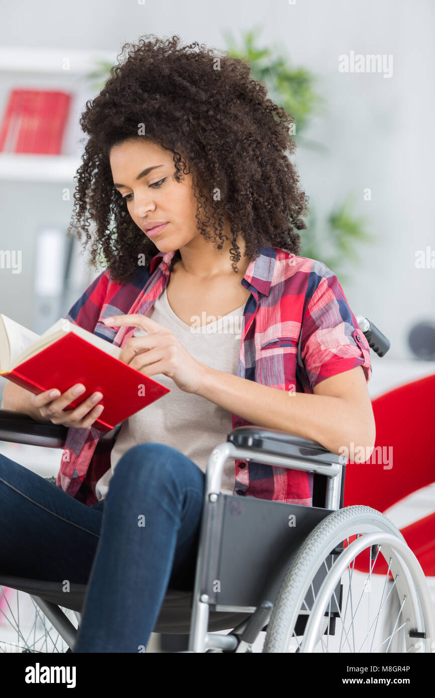 optimistic handicapped woman readying Stock Photo - Alamy