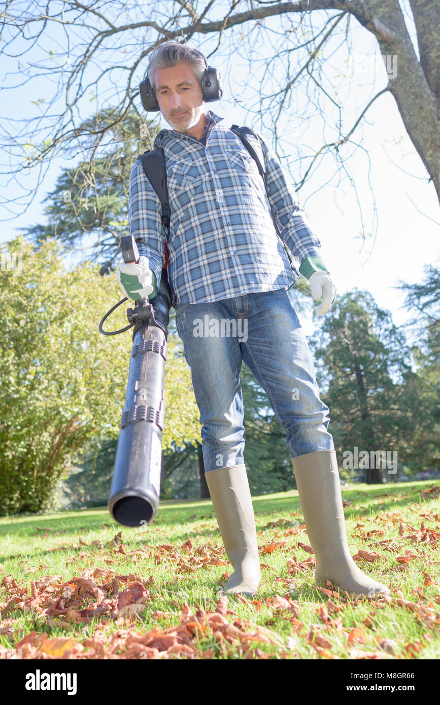 Man using leaf blower Stock Photo - Alamy