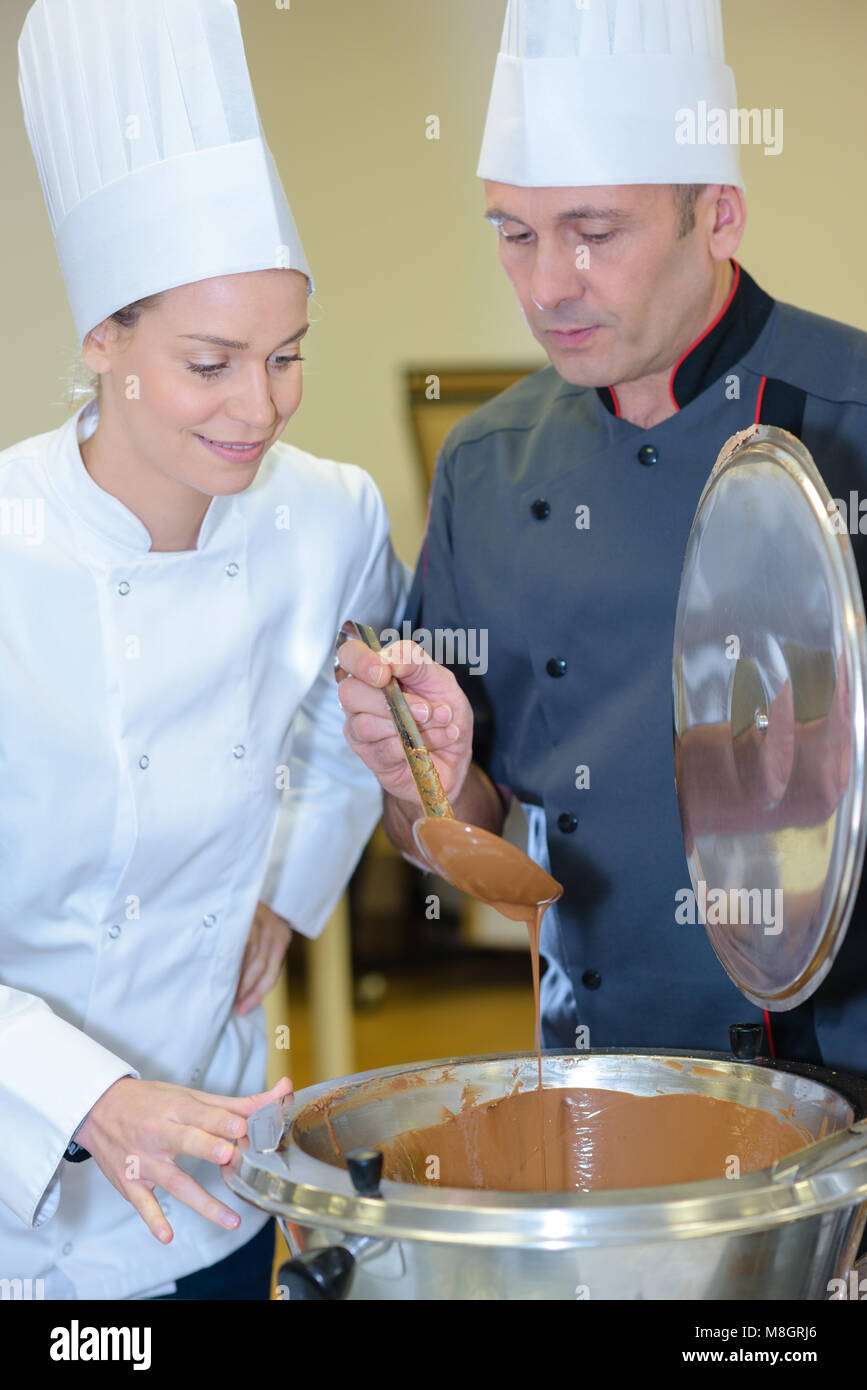 chefs preparing praline topping for their delicious pastries Stock ...