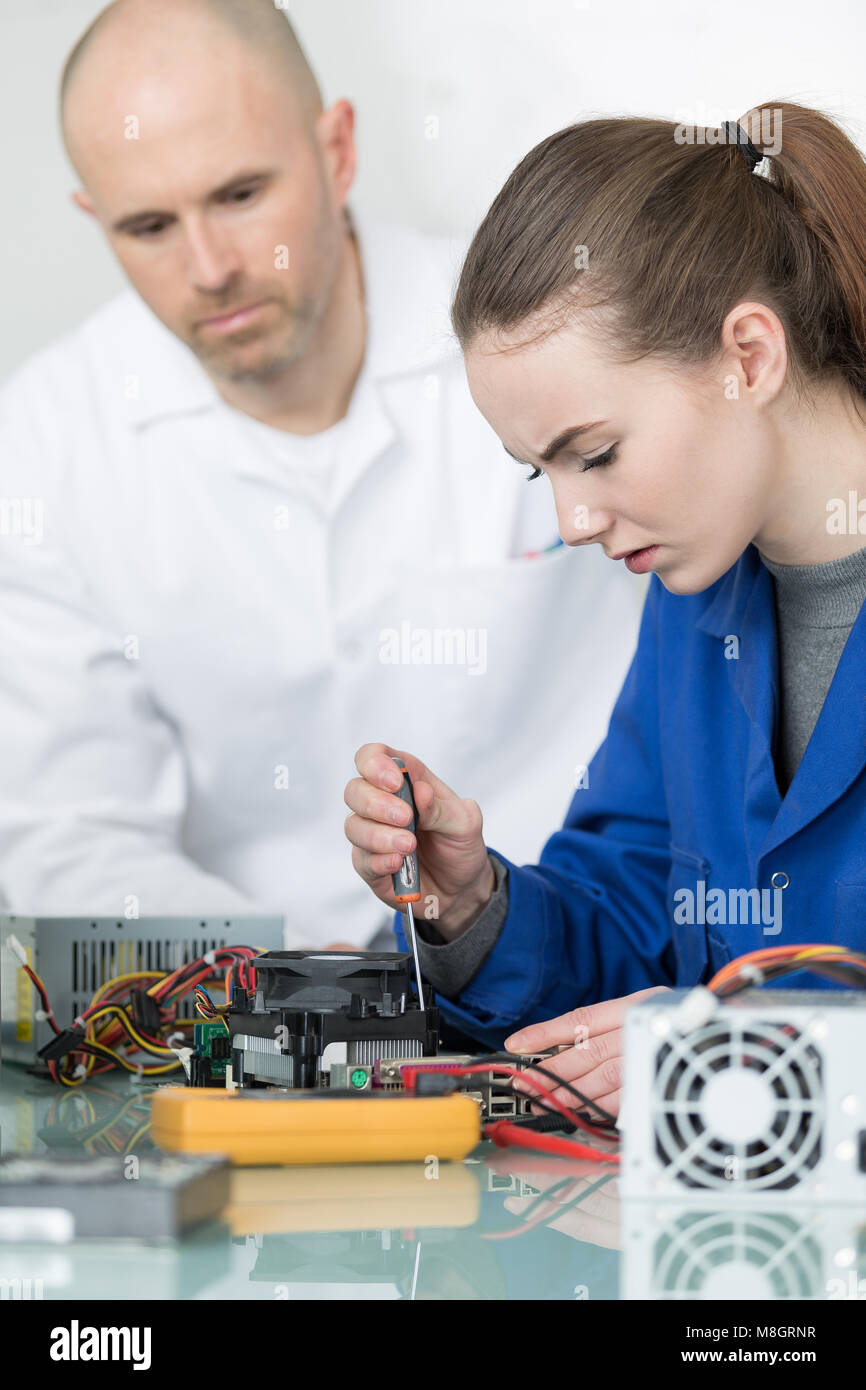 engineering student working on circuit with teacher Stock Photo - Alamy