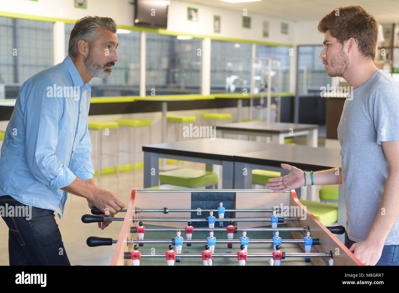 table soccer playing Stock Photo - Alamy