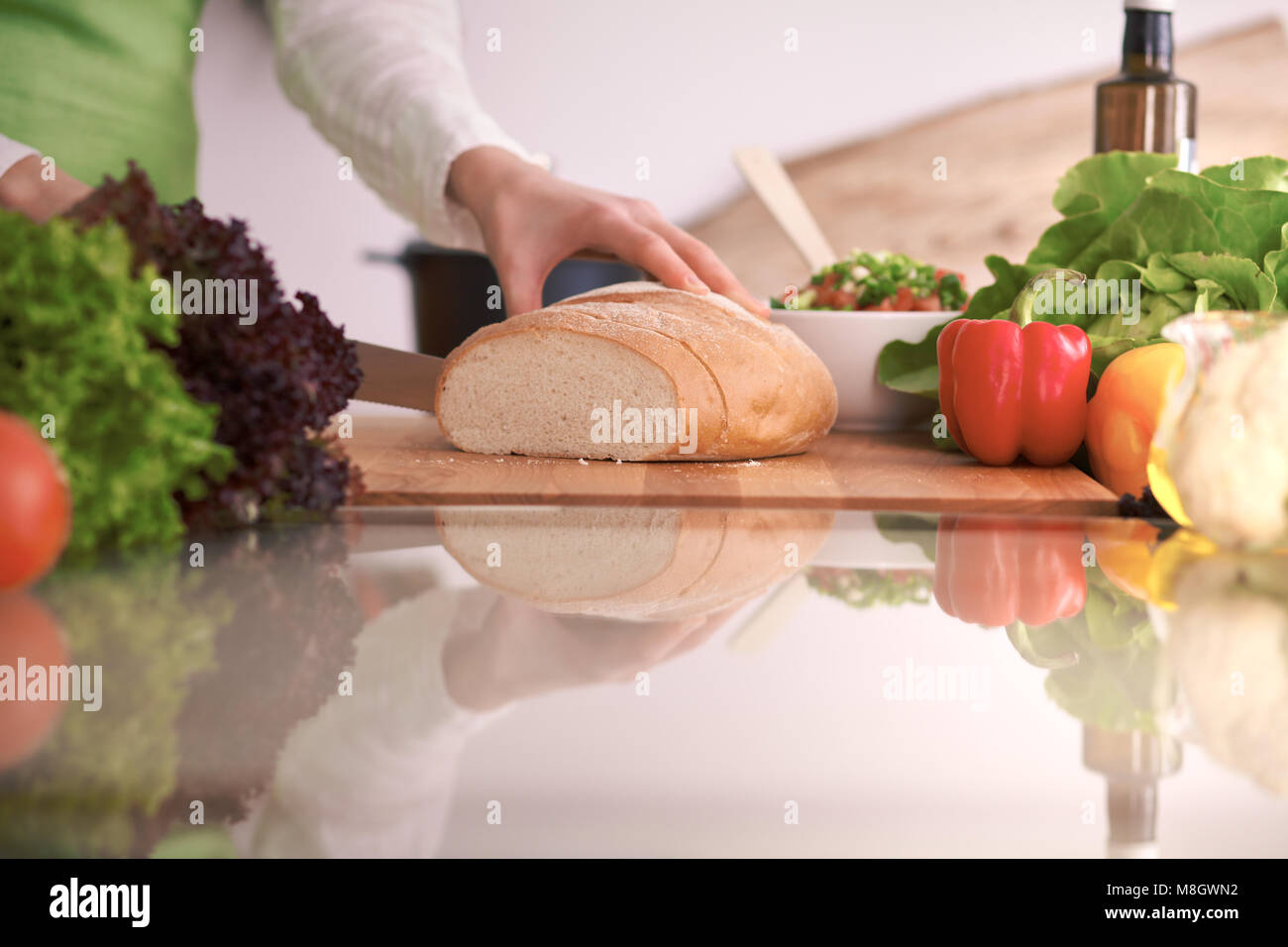 Closeup of human hands cooking in kitchen on the glass table with ...