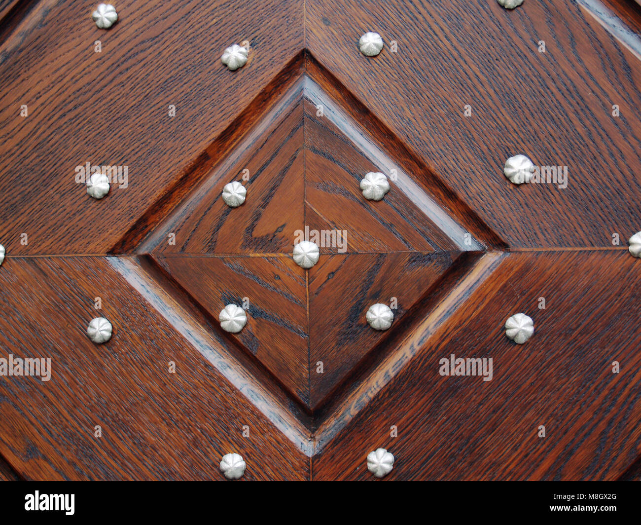 Detail of wooden door with rivets Stock Photo - Alamy