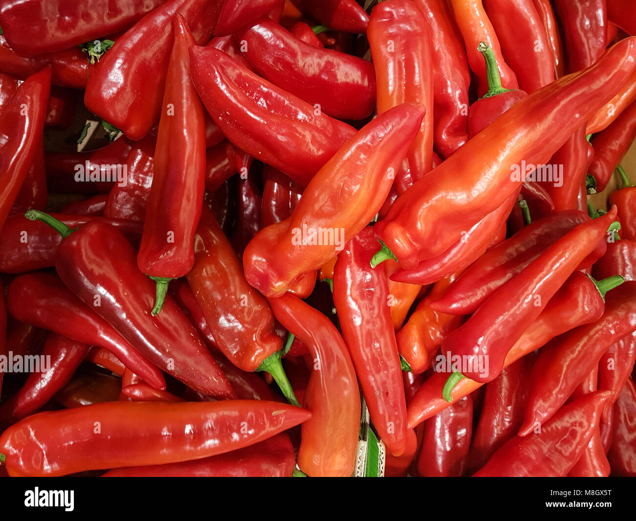 pepers red pile for food colors background Stock Photo - Alamy
