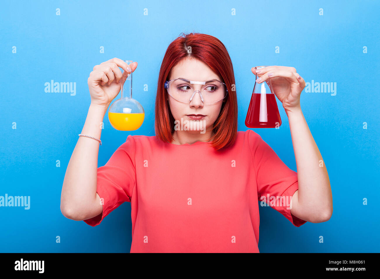 Science chemist girl with two flasks in hand Stock Photo - Alamy