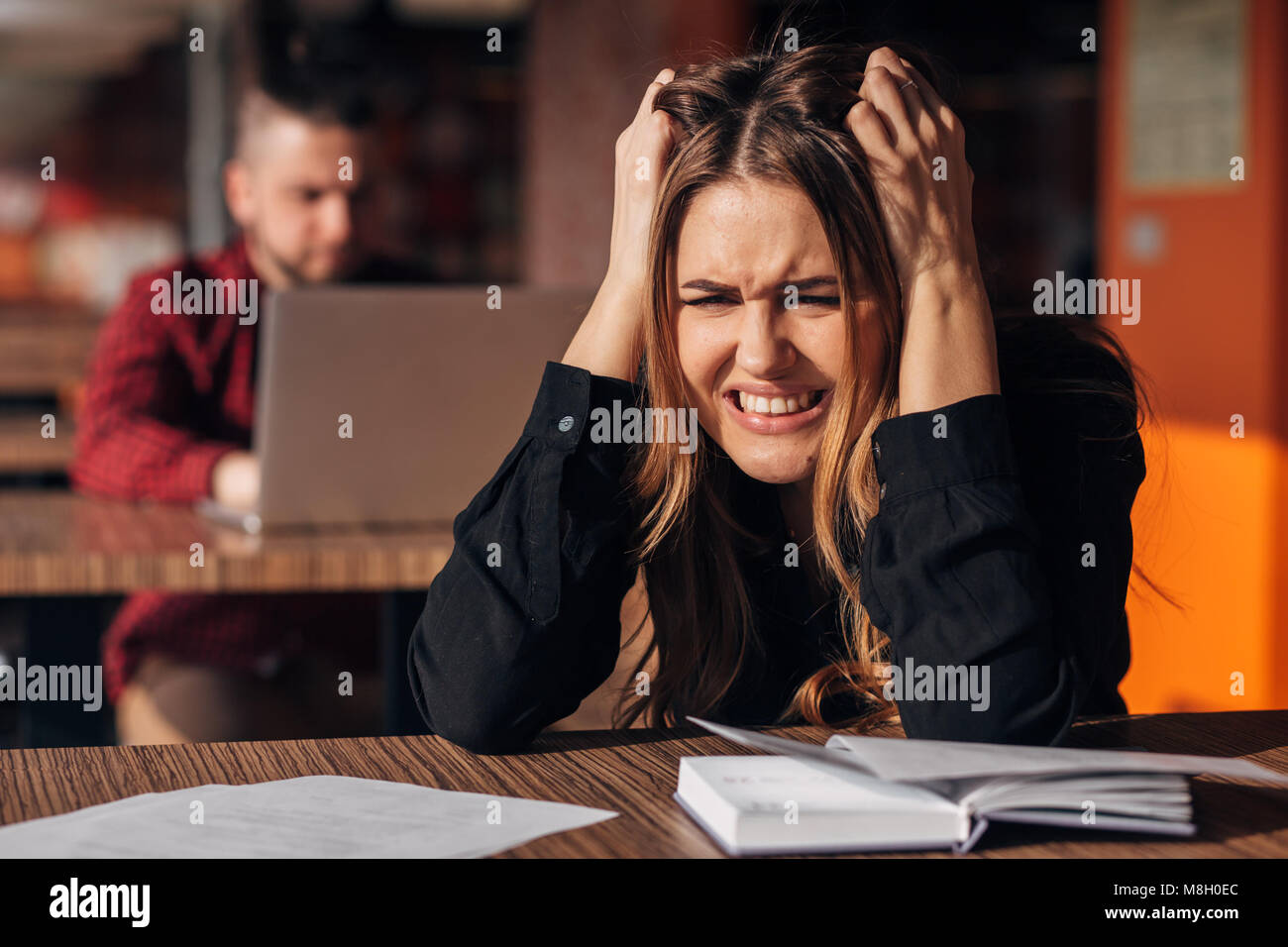 tired businesswoman holding hands on her head Stock Photo - Alamy